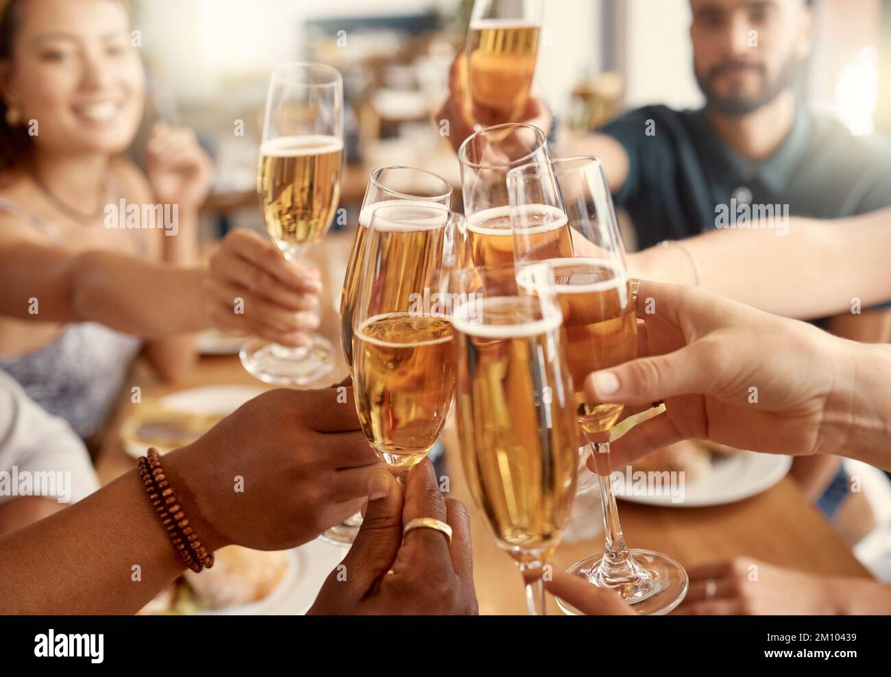 The only way to celebrate. a group of friends toasting in restaurant ...