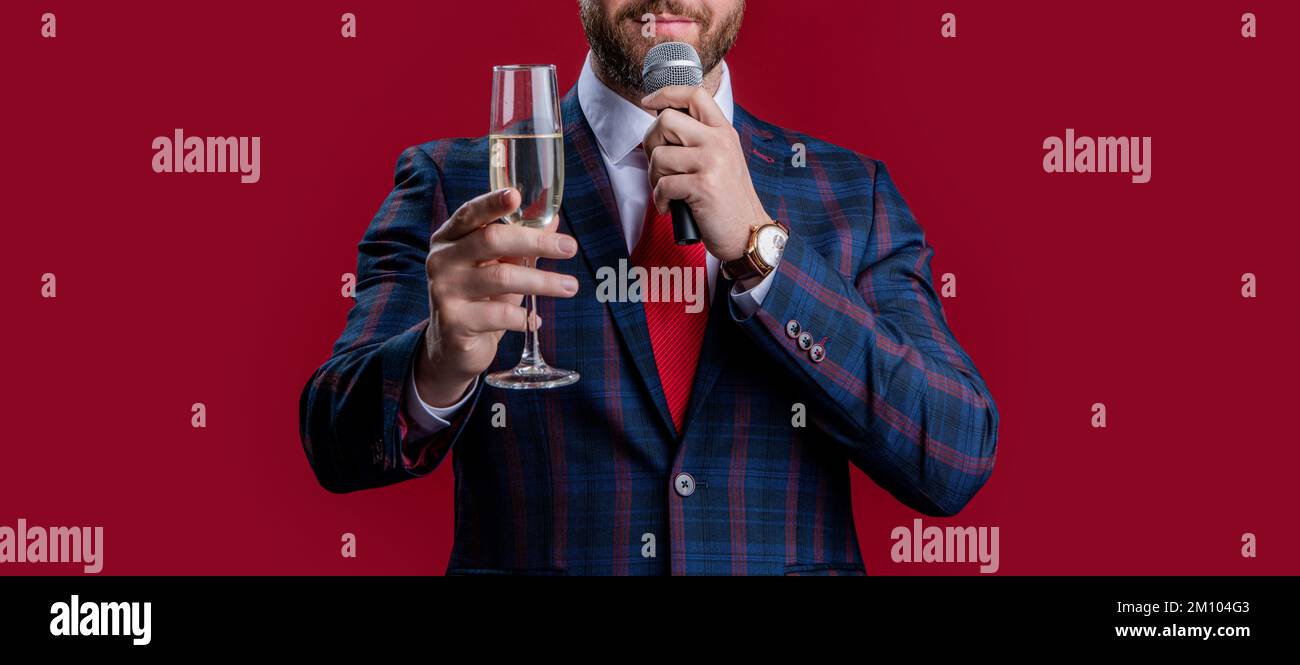 presenter cheering and hold microphone isolated on red background ...