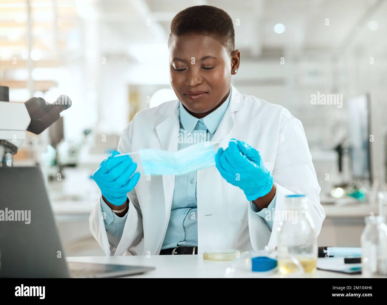 Safety first. an attractive young scientist sitting alone in her ...