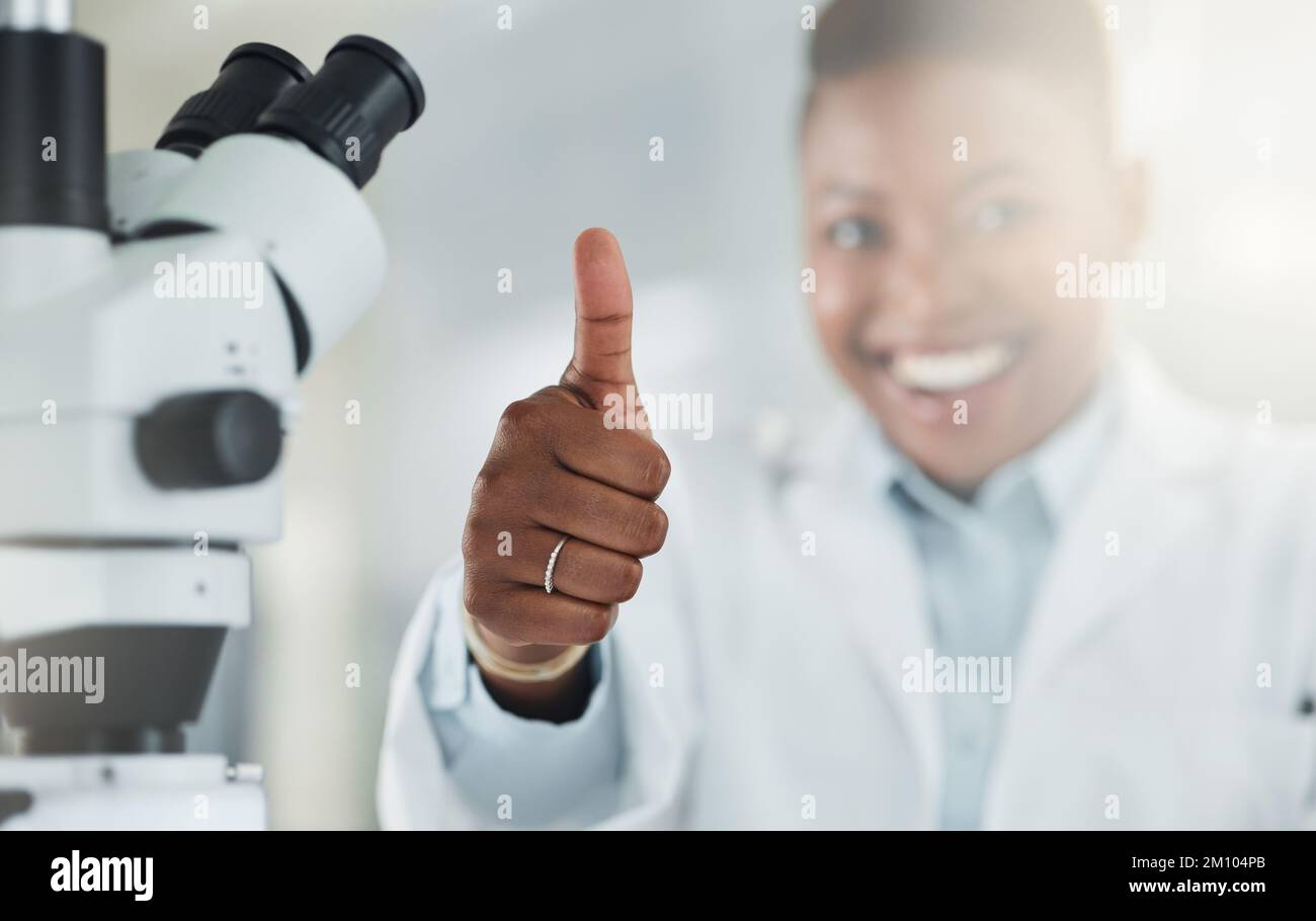 Building a better world through science. a scientist showing thumbs up ...