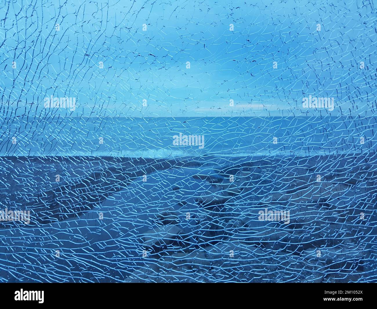 Abstract blue broken glass with a lot of cracks shot window on ocean ...