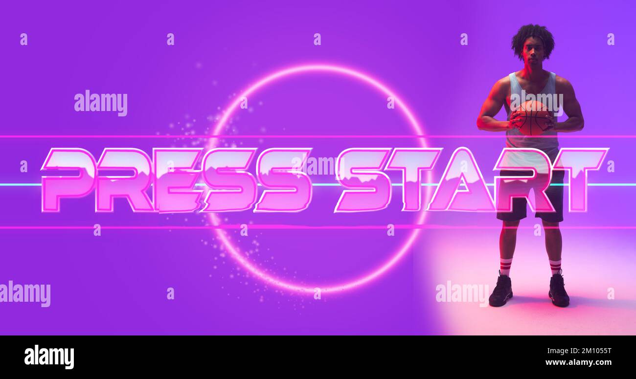 Composite of illuminated press start text and circle by biracial male ...