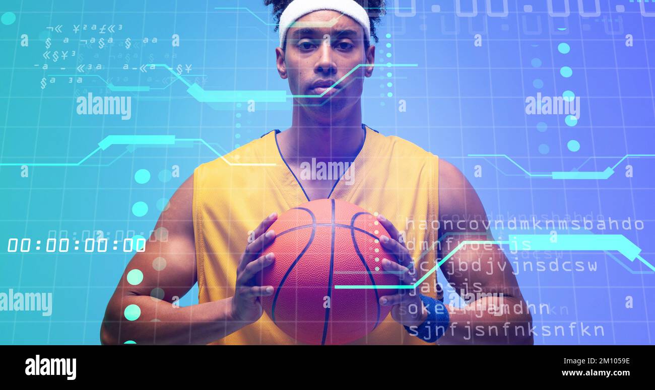 Portrait of biracial male player holding basketball over grid pattern ...