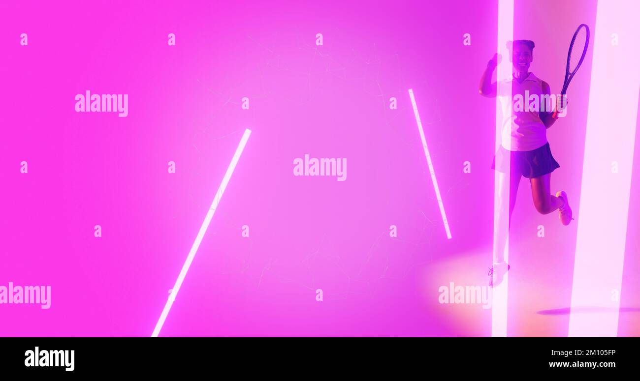 Full length of cheerful biracial female tennis player with racket ...