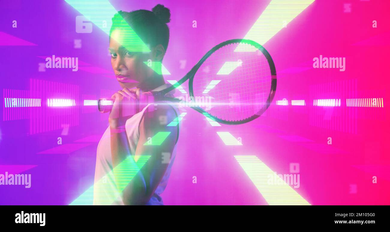 Side view of biracial female tennis player with racket standing over ...