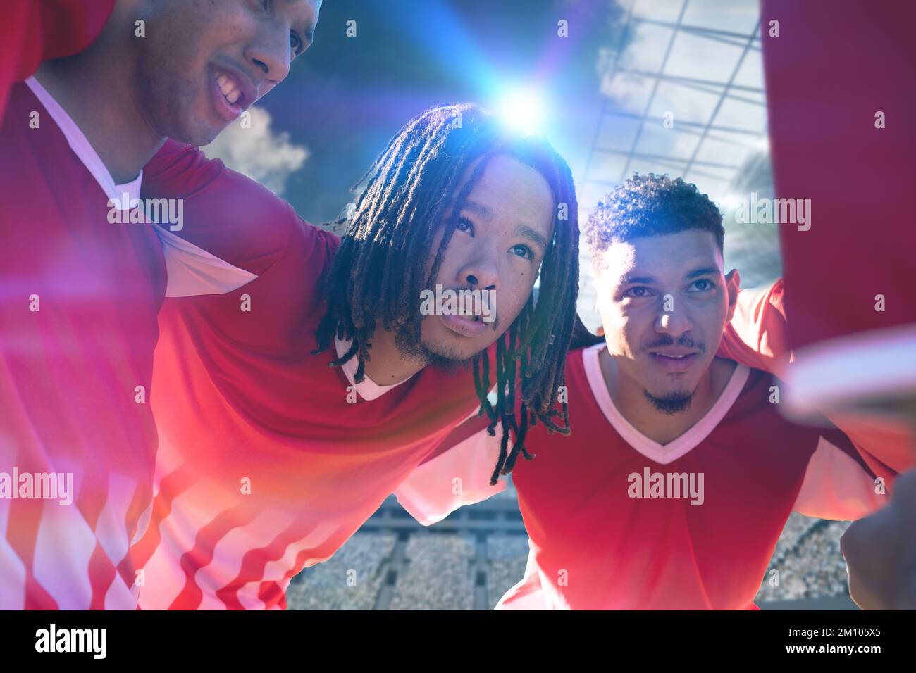 Multiracial young male players huddling and planning match strategy at ...