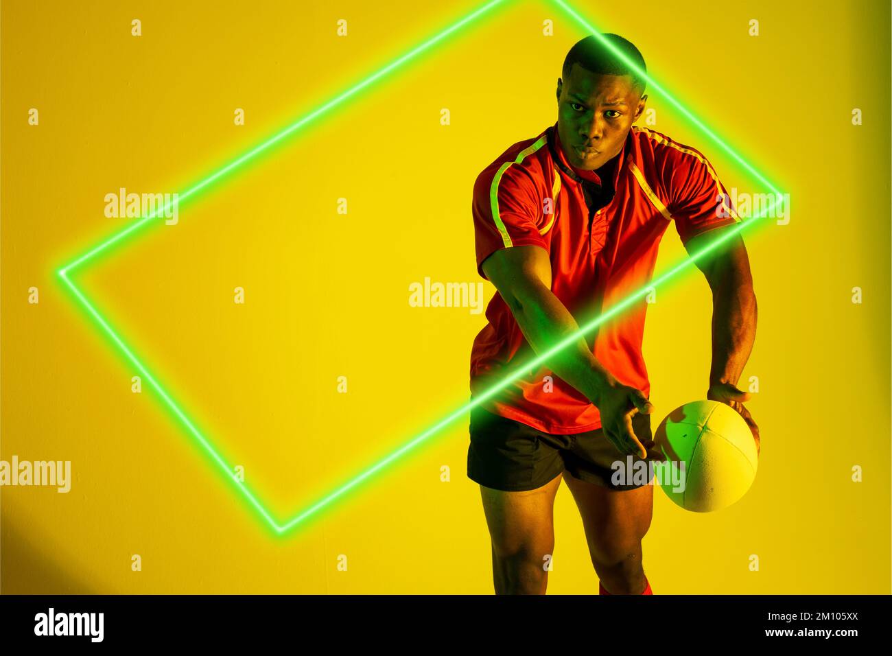 Rectangle neon over african american young rugby player playing against ...