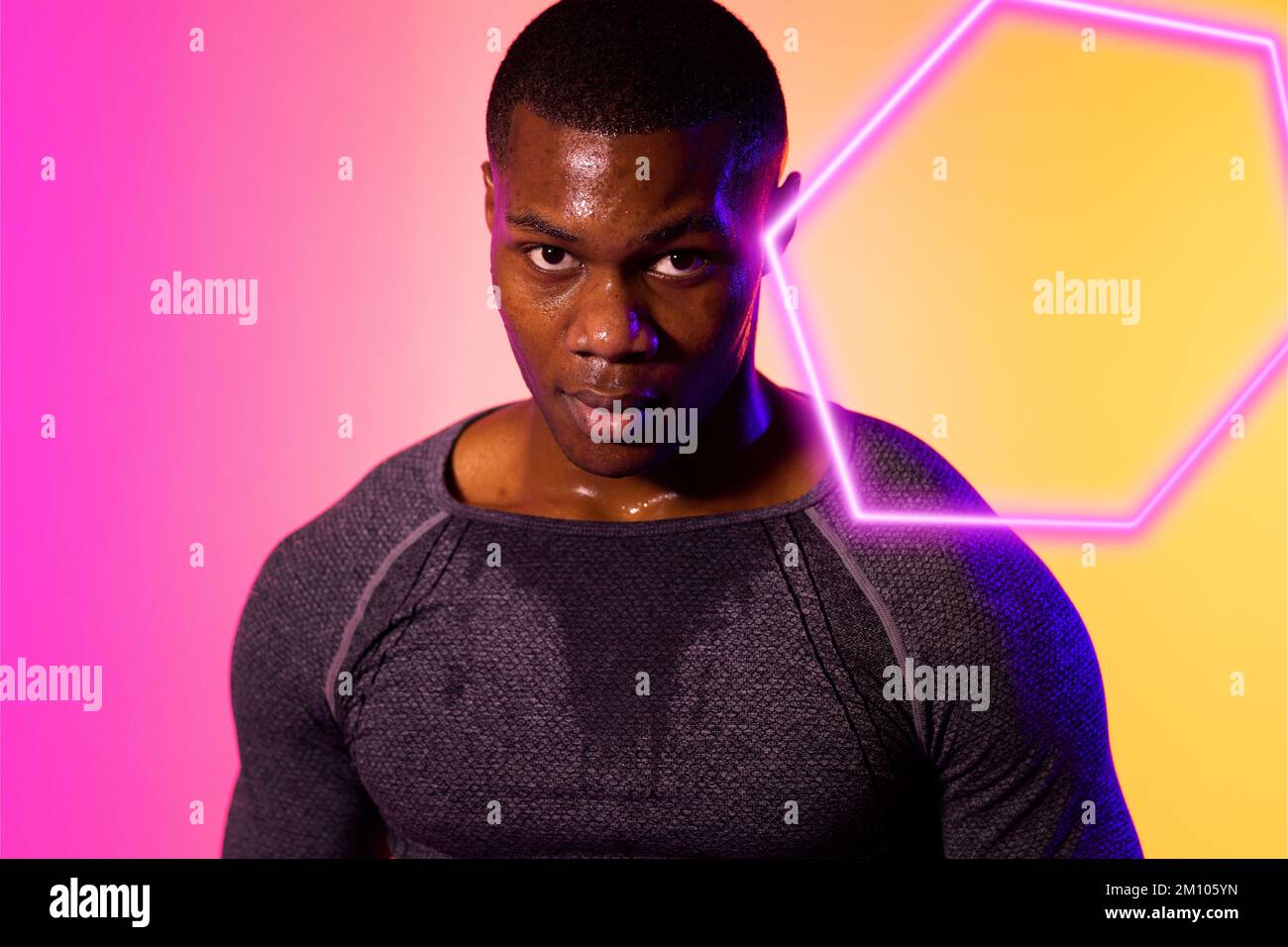 Hexagon neon over determined african american young sportsman in sweat ...