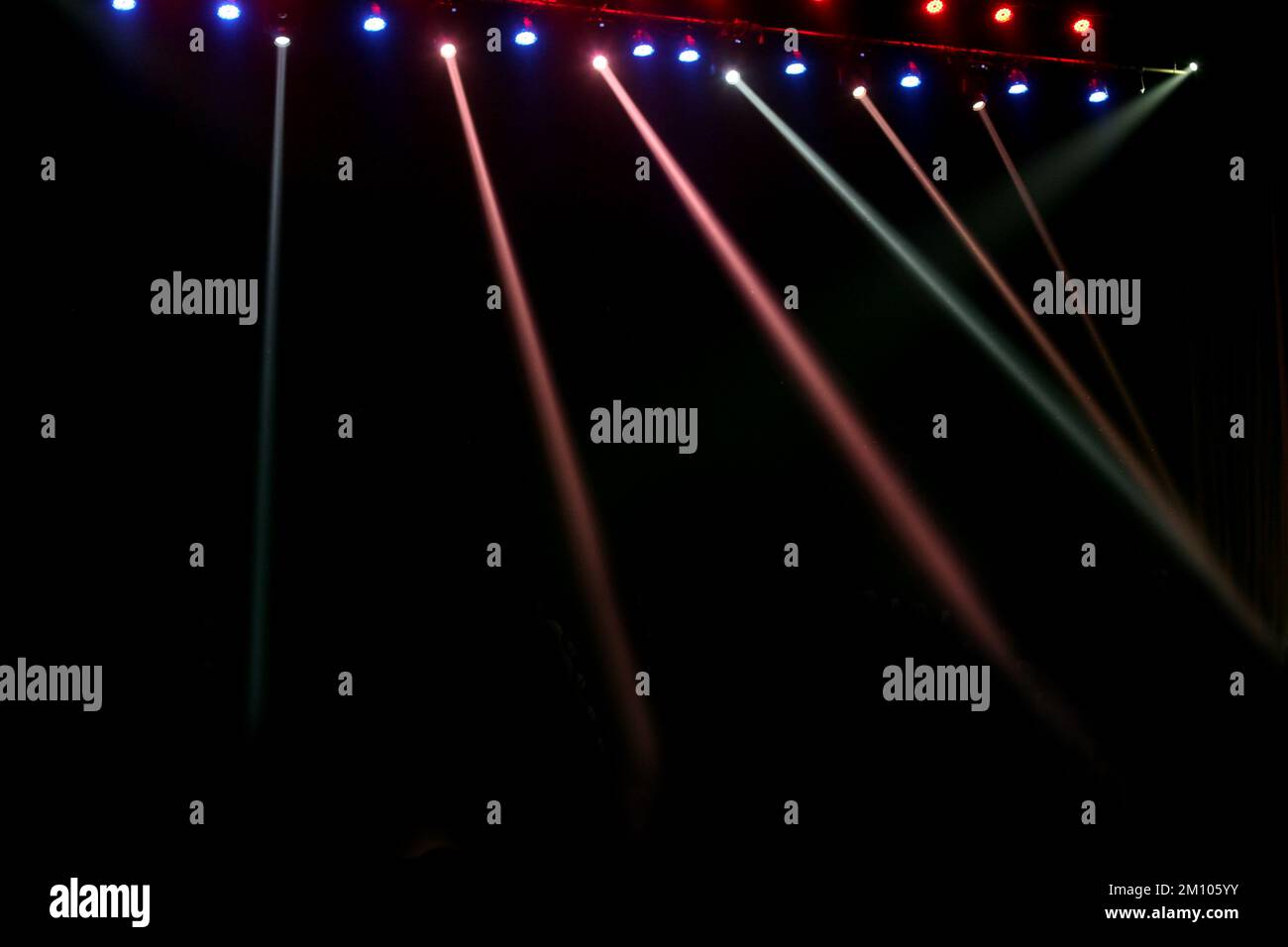 Blue, red and white concert stage show party lights on black background ...