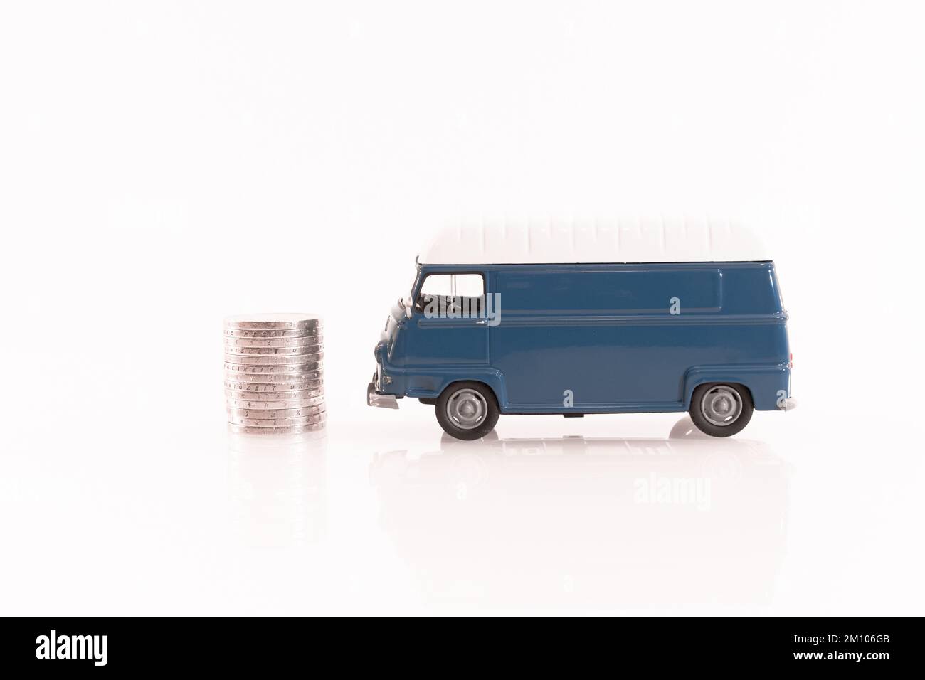 Miniature van type vehicle with coins Stock Photo - Alamy