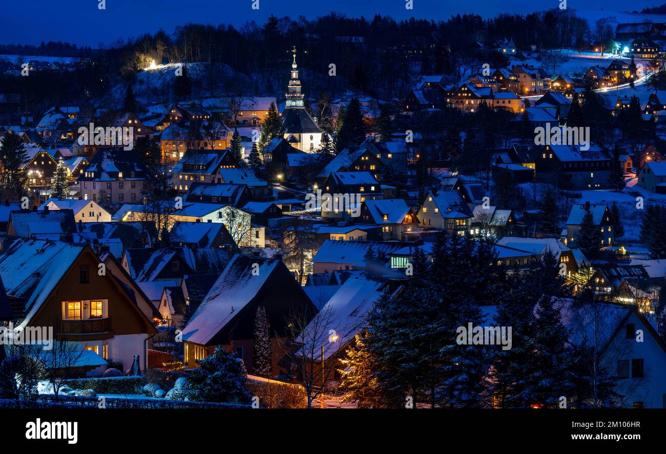 08 December 2022, Saxony, Seiffen: The toy village of Seiffen shines in ...