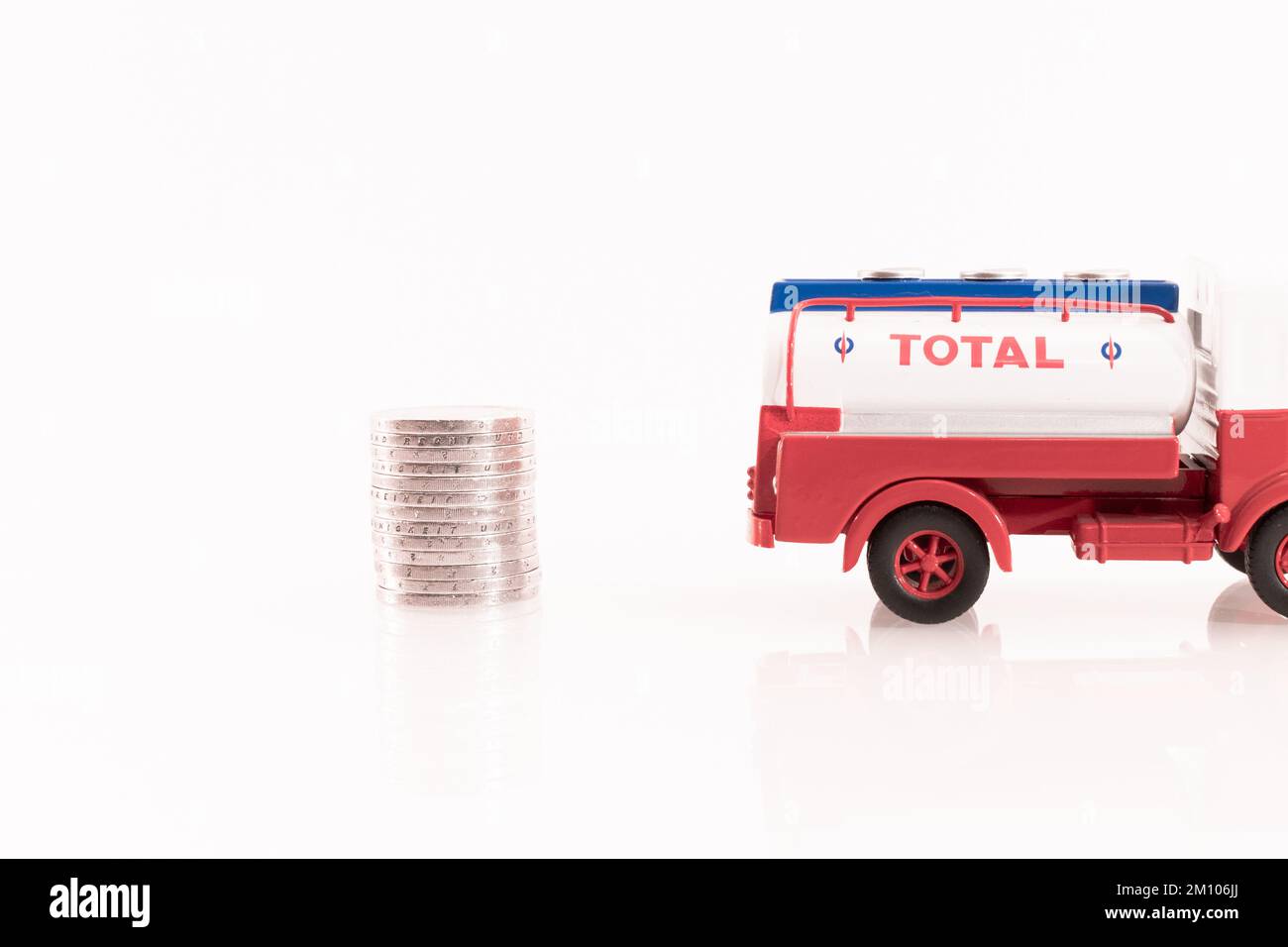 Miniature vehicle of a Total tanker with coins Stock Photo - Alamy