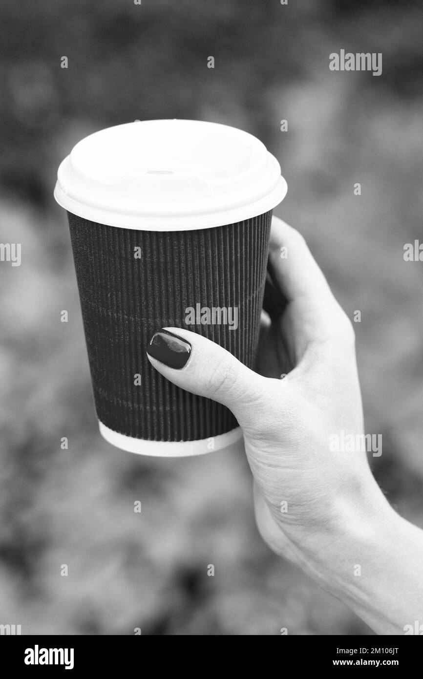 female hand hold morning coffee cup on colorful background, takeaway ...