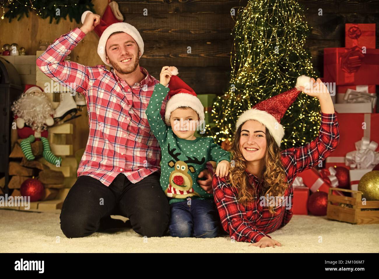 Parenthood happiness. Christmas tradition. Father mother little son ...
