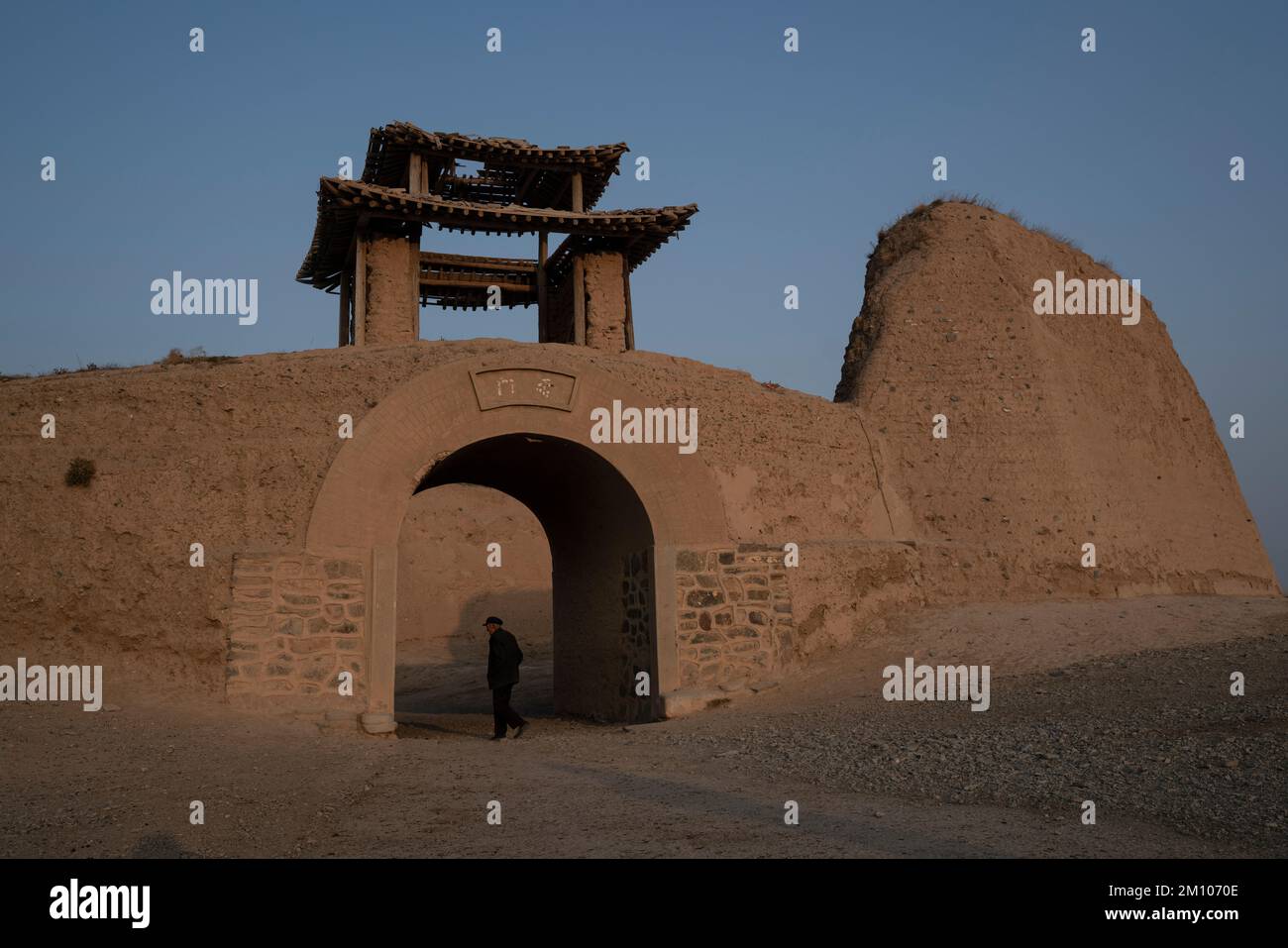 An old man walk through the Ancient Chinese castle gate Stock Photo - Alamy