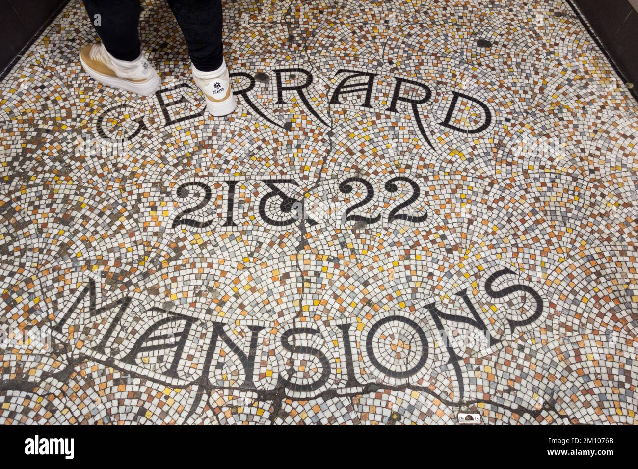 Cracked mosaic tiled doorstep at Gerrard Mansions, Gerrard Street, Soho ...