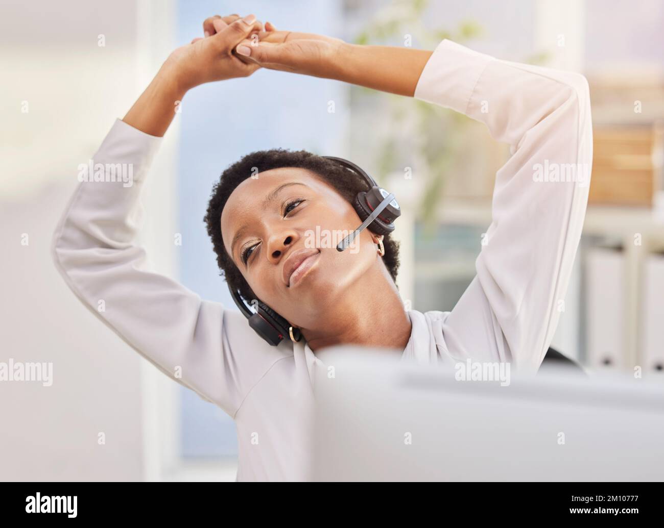 Black woman, call center and stretching in office at desk to prepare ...