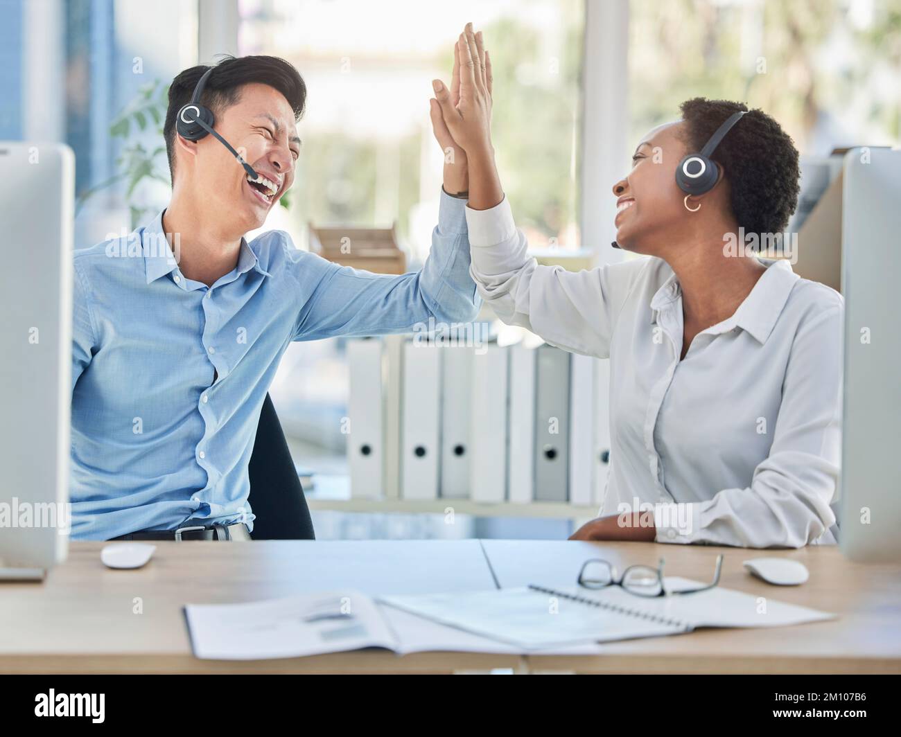 Call center, high five and teamwork success, celebration and ...