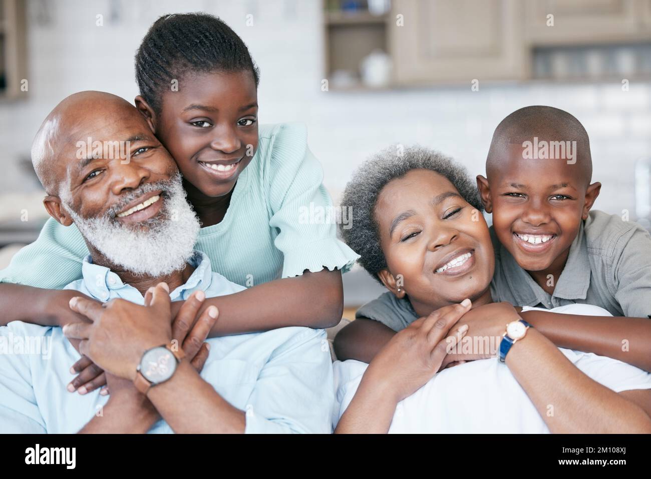 We are family. grandparents bonding with their grandchildren on a sofa ...