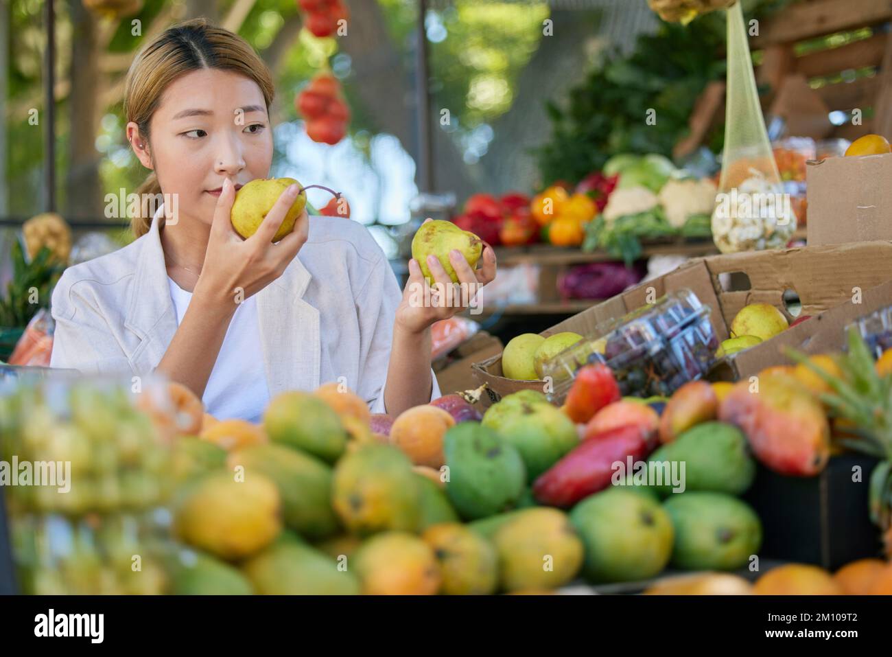 Woman smelling fruit at grocery store hi-res stock photography and ...