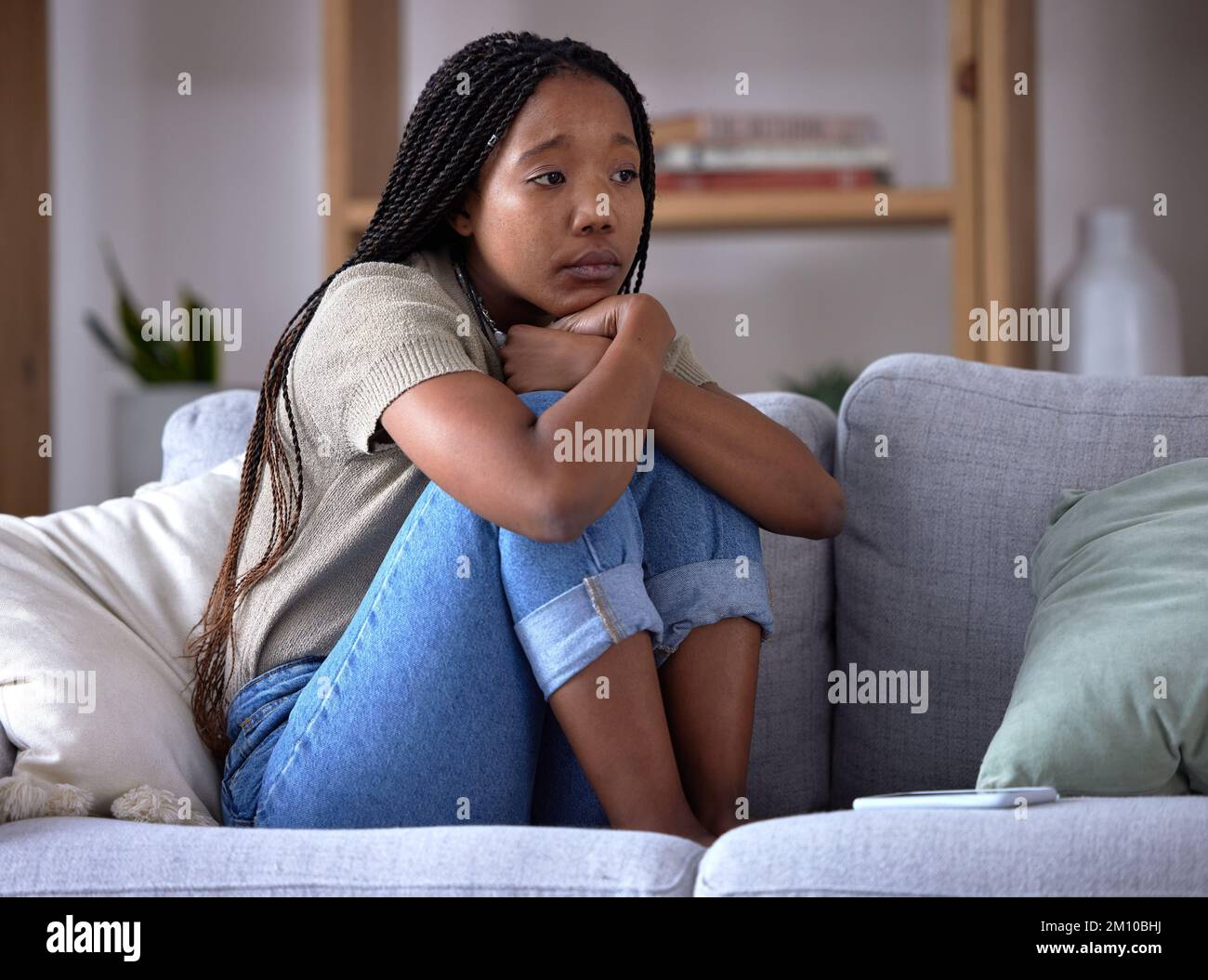 Sad, depression and lonely black woman on sofa with mental health issue, problems and stress ...