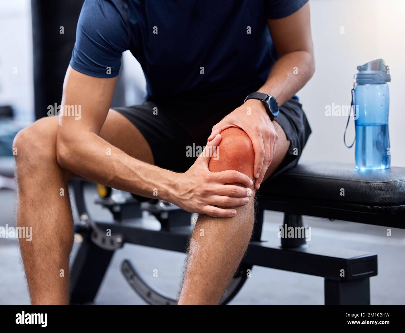 Exercise, man and knee pain in gym, bench and injury after practice ...