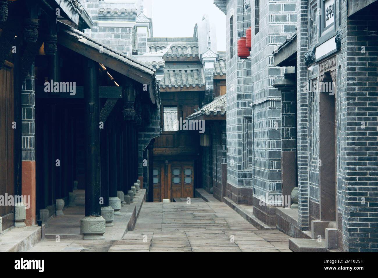 A narrow street in between stone houses Stock Photo - Alamy