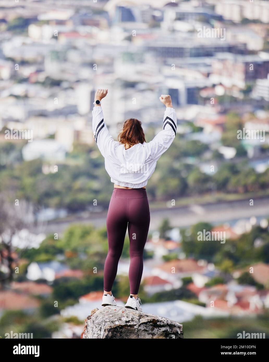 Fitness, celebration and woman on mountain with arms raised for victory ...