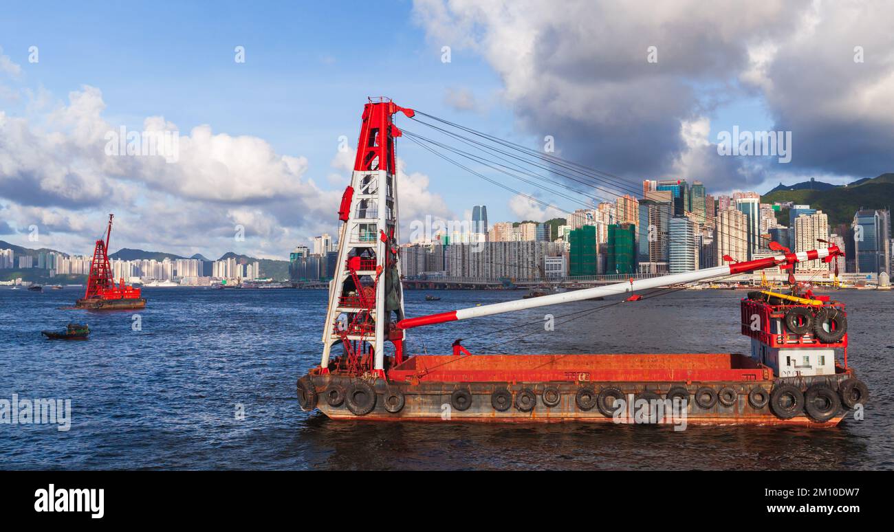Floating cranes sails the Hong Kong bay on a sunny day Stock Photo - Alamy