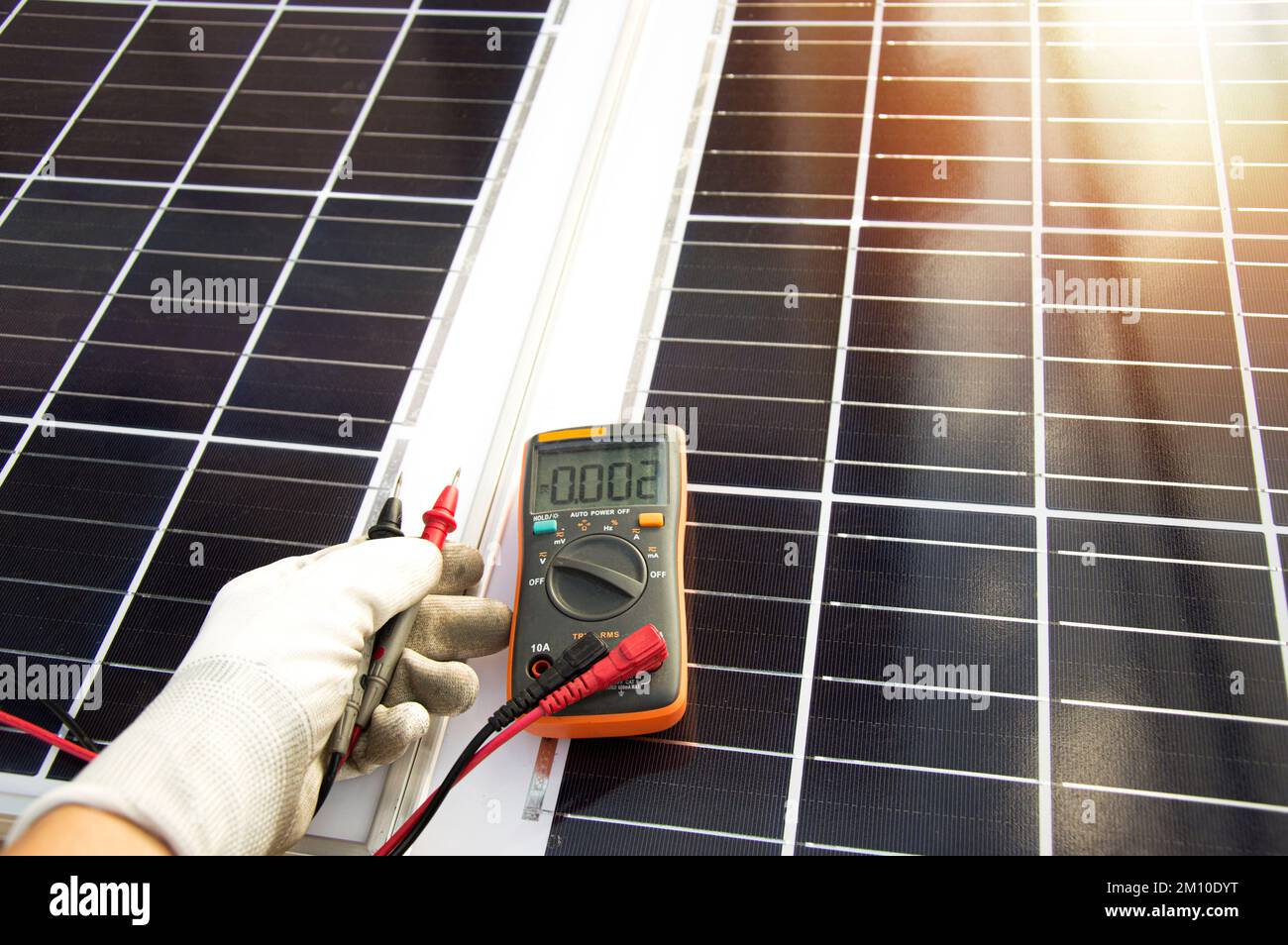 Technician inspecting solar panel installation Stock Photo - Alamy