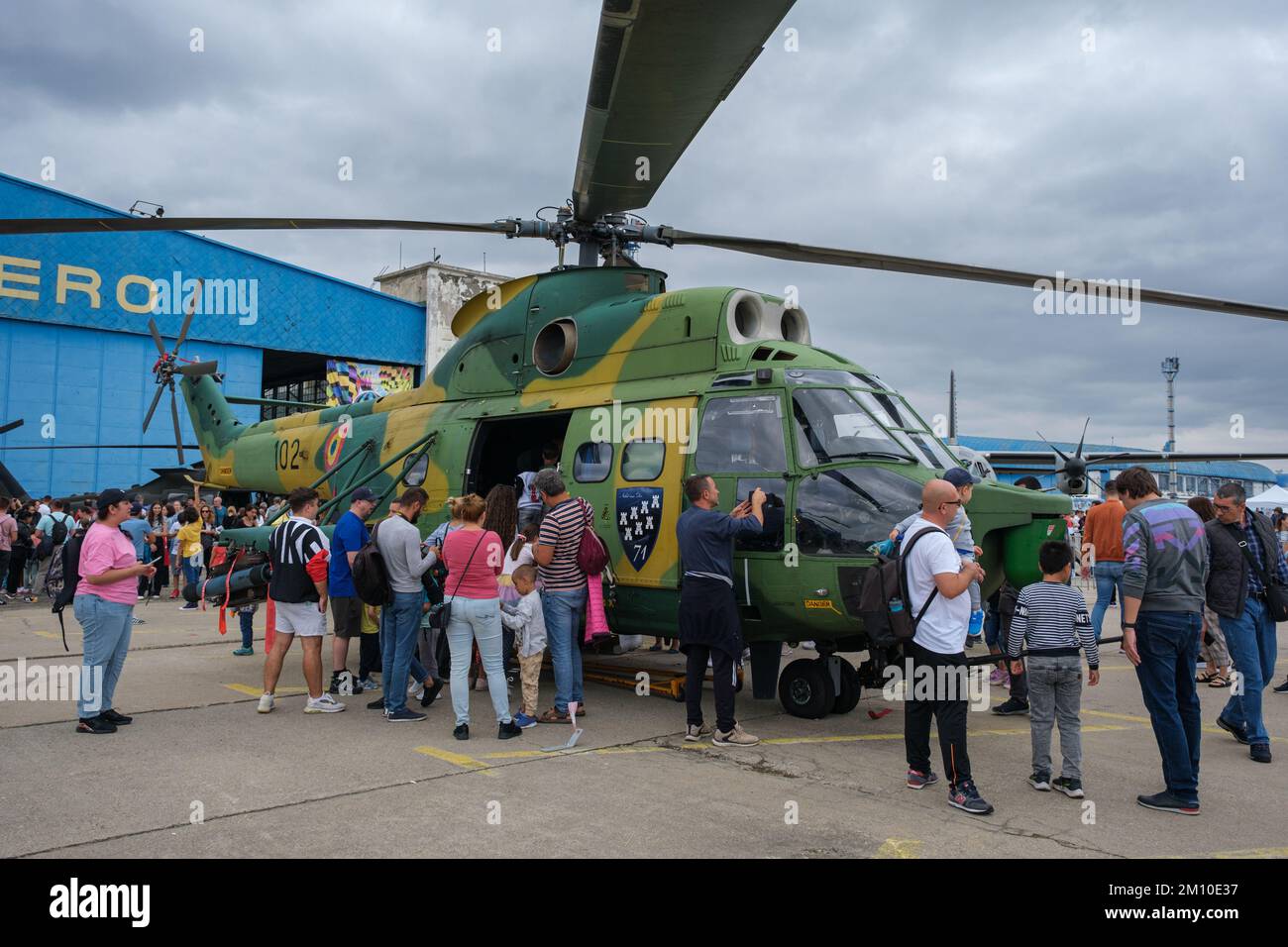 A group of people gathered around IAR 330 aircraft at Bucharest ...