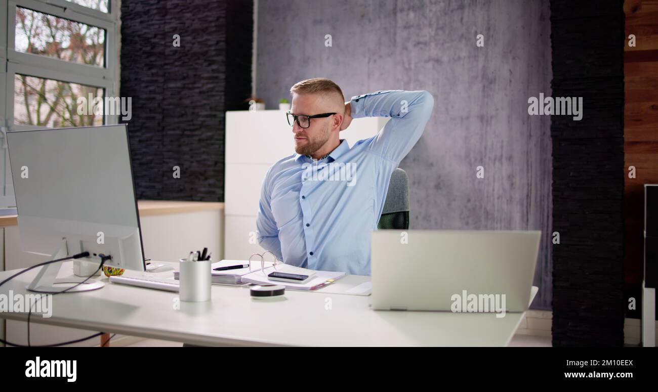 Advisor Man Relaxing In Office Chair At Desk Stock Photo - Alamy