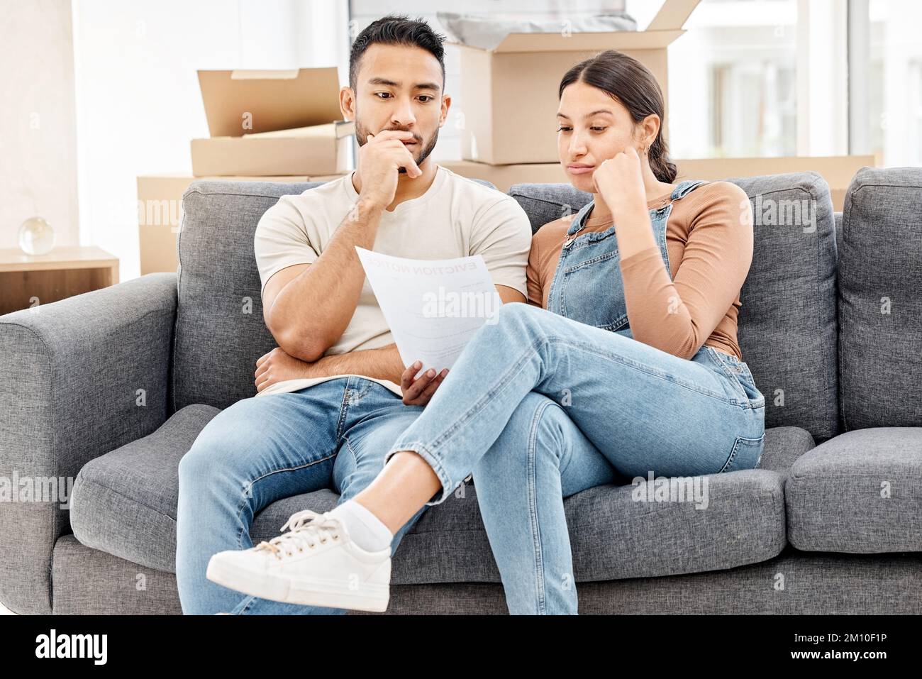 We need to make a plan about this. a young couple looking worried and ...