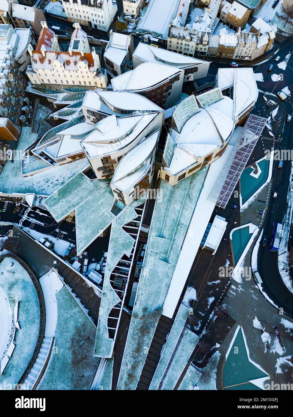 Aerial view of winter snow covered roofs of Scottish Parliament ...