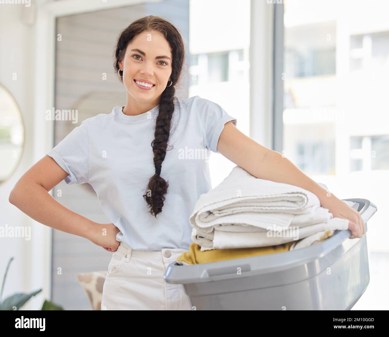 Woman, laundry basket and home portrait in lounge, room and cleaning ...