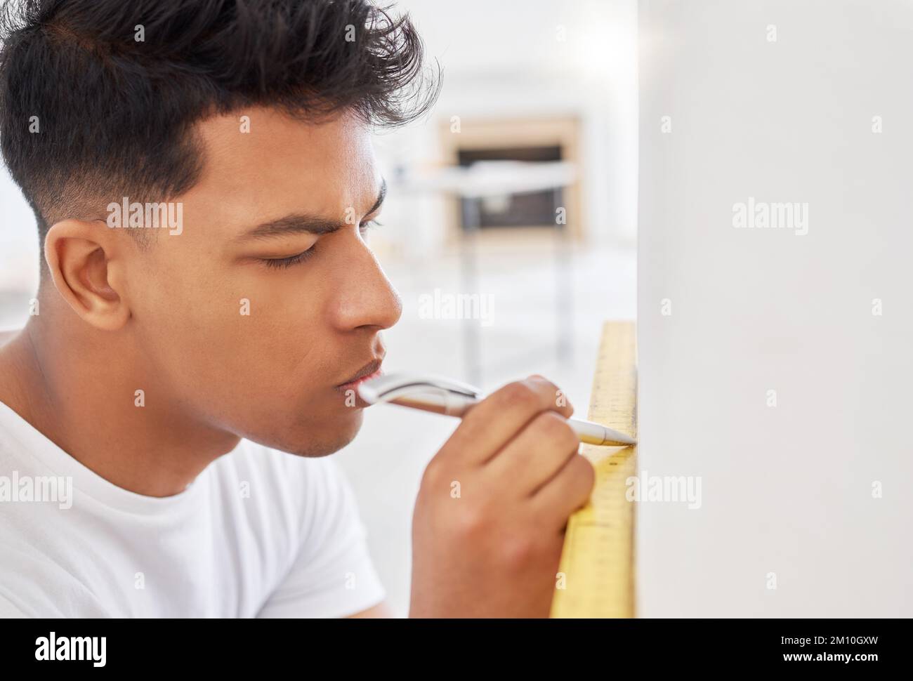 This is where I draw the line. a man using a spirit level while ...