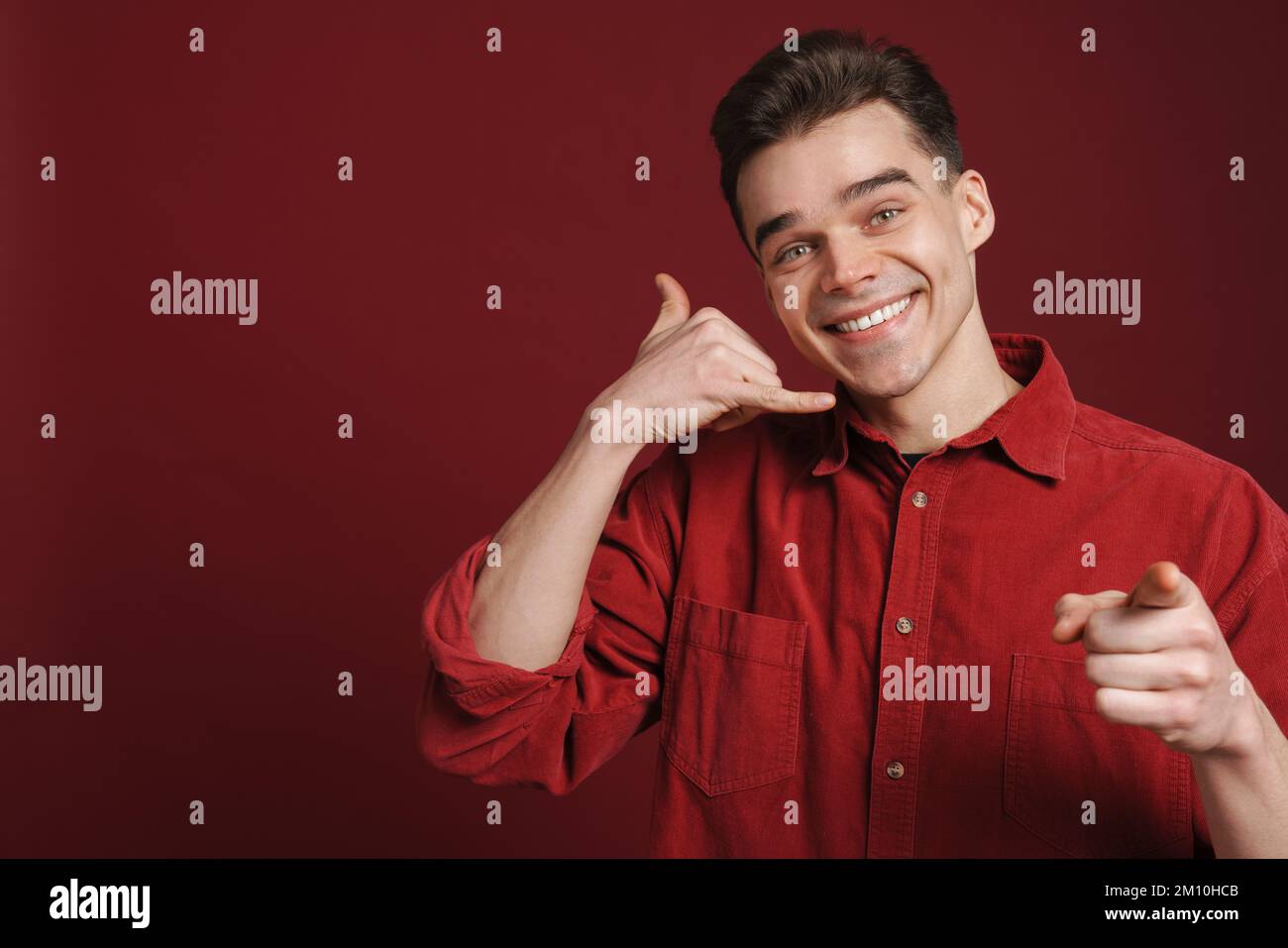 Young white man gesturing and pointing finger at camera isolated over ...
