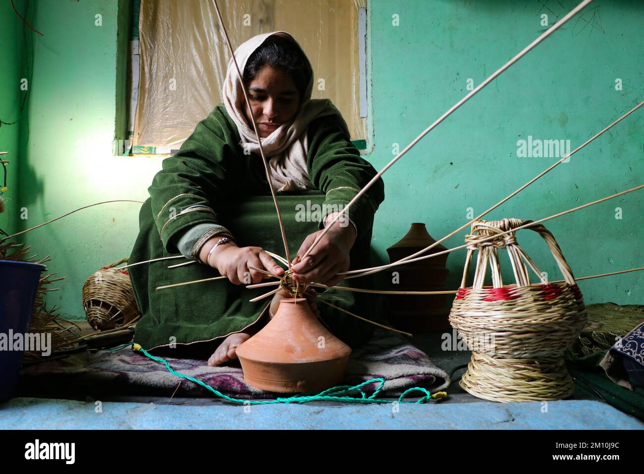 December 9, 2022, Budgam, Jammu and Kashmir, India: Mubeena weaves ...