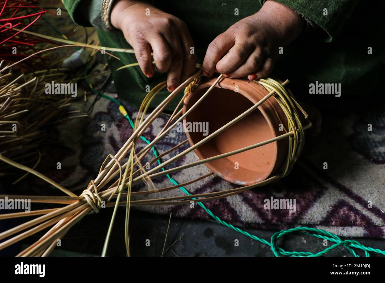 December 9, 2022, Budgam, Jammu and Kashmir, India: An artisan weaves ...