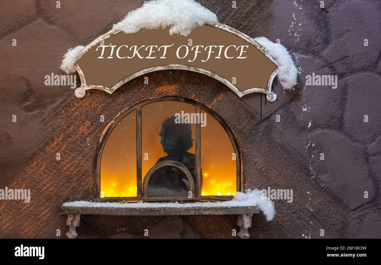 Close-up of an old stone building with an arched window and a ticket ...