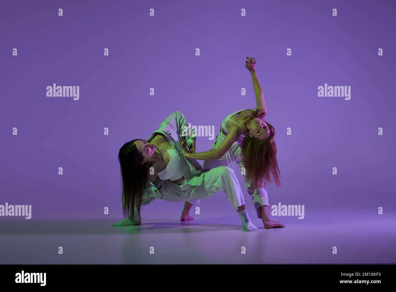 Experimental dance. Two young girl in motion, action isolated over ...