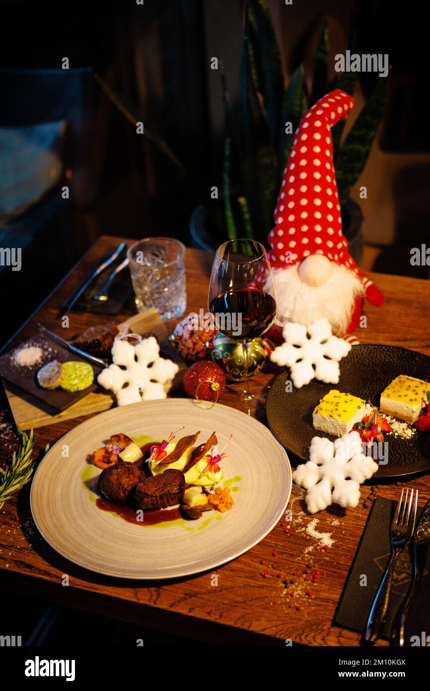 Deer tenderloin and dessert. Christmas table served for eve celebration ...