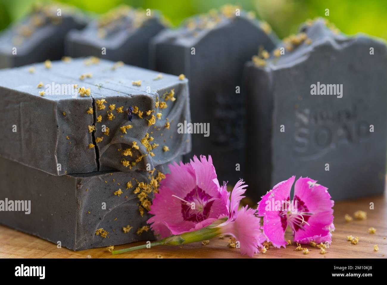 Dark blue handmade soap with pink flowers on a green background Stock ...