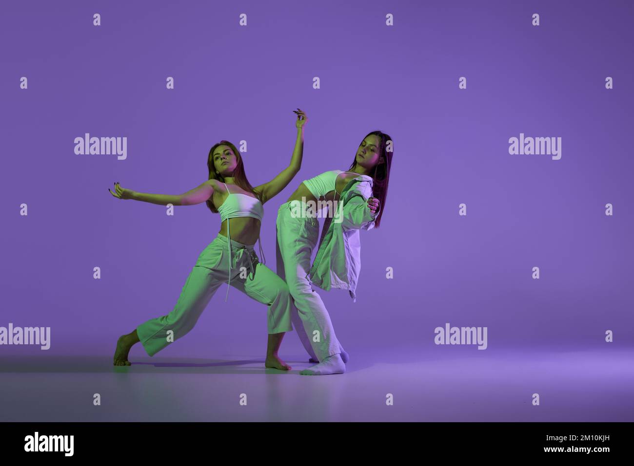 Studio footage of dancing young girls. Stylish performance. Two young ...