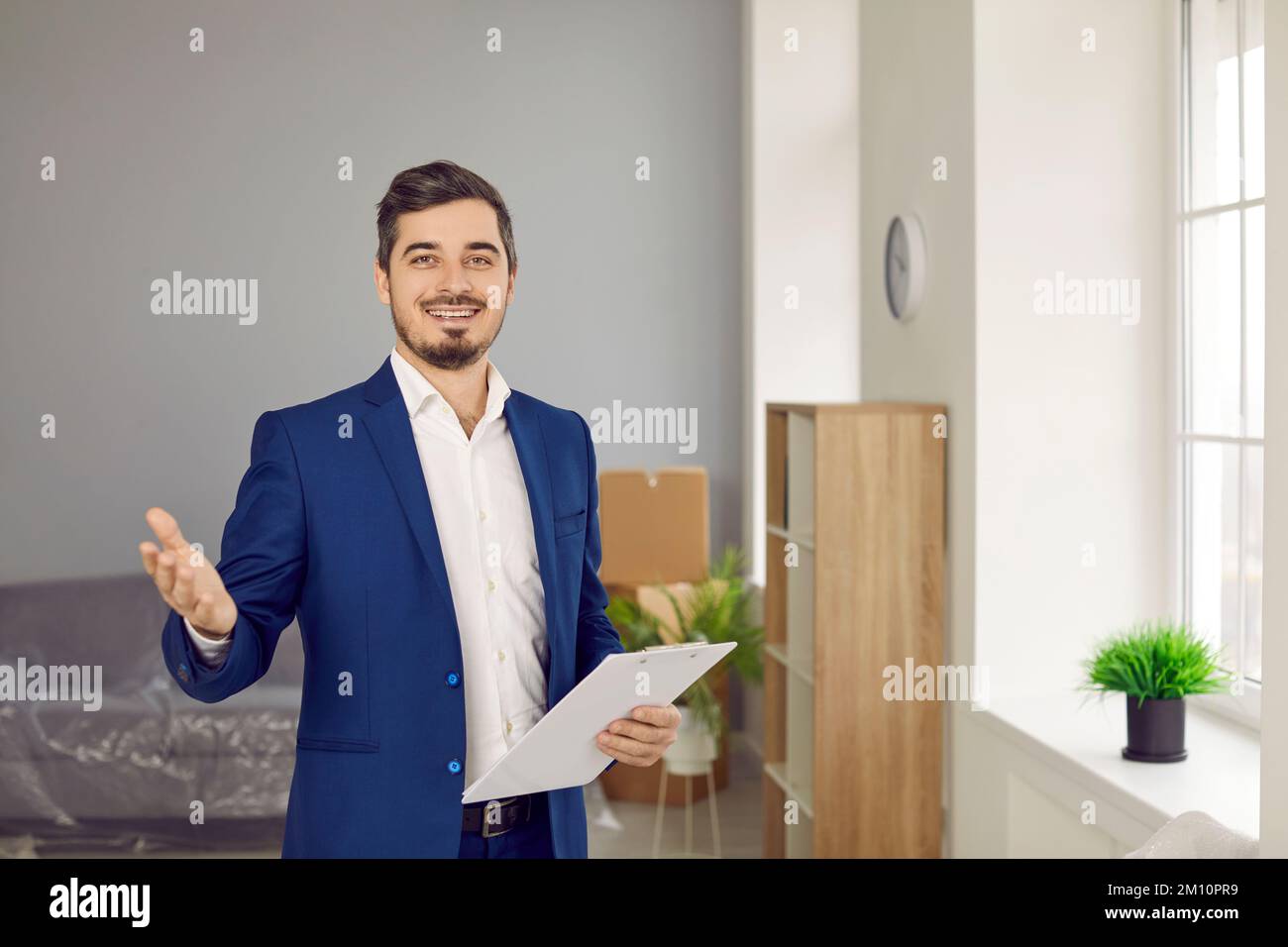 Portrait of professional realtor or real estate agent holding clipboard ...