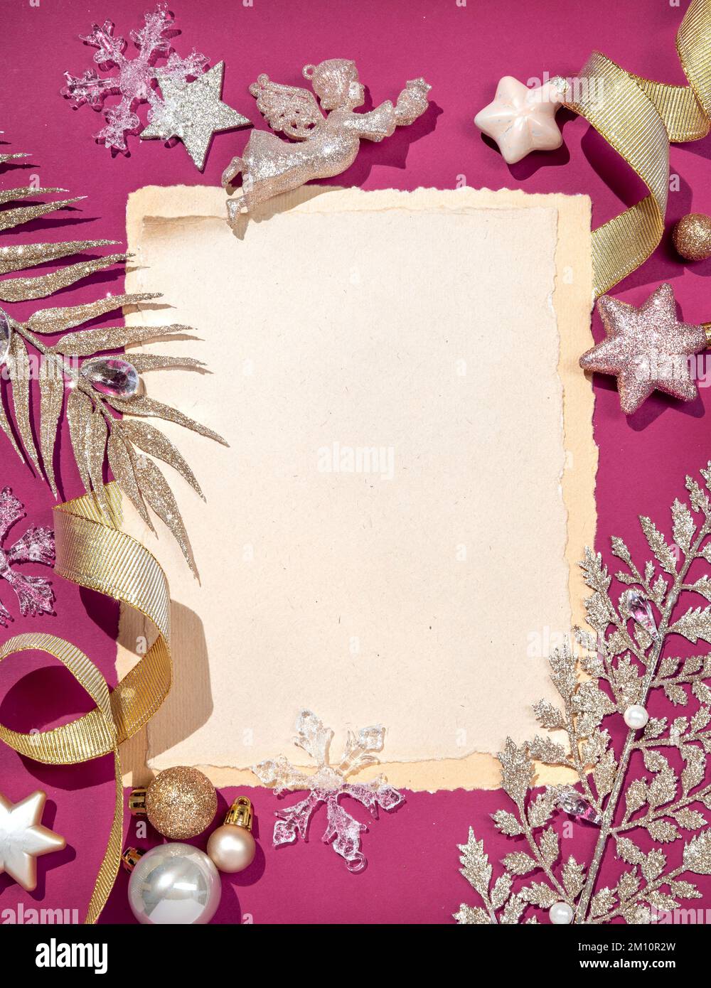 Christmas letter with shiny branches and decoration toys on pink ...