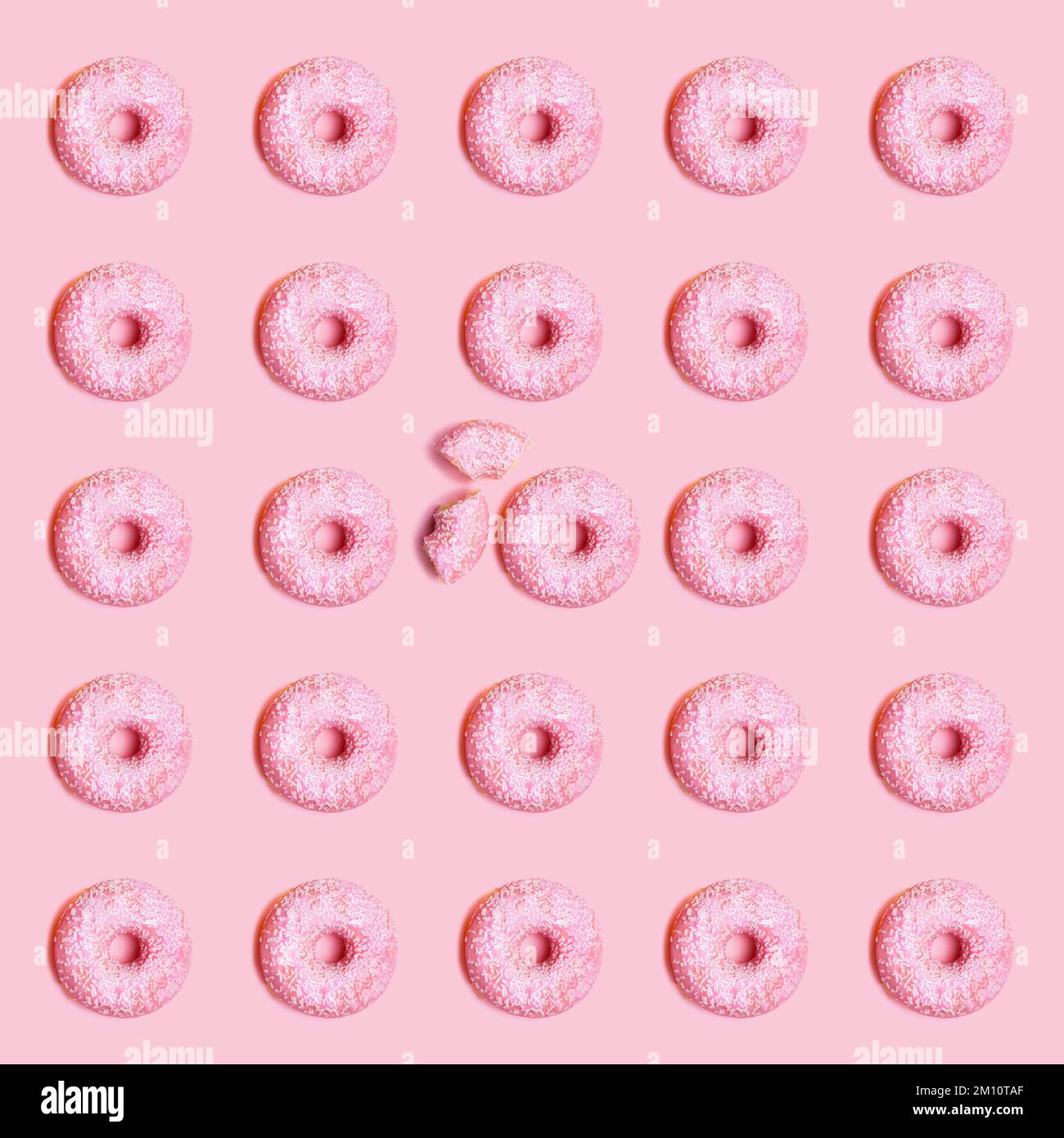 A pattern of pink donuts on a light pink background Stock Photo - Alamy