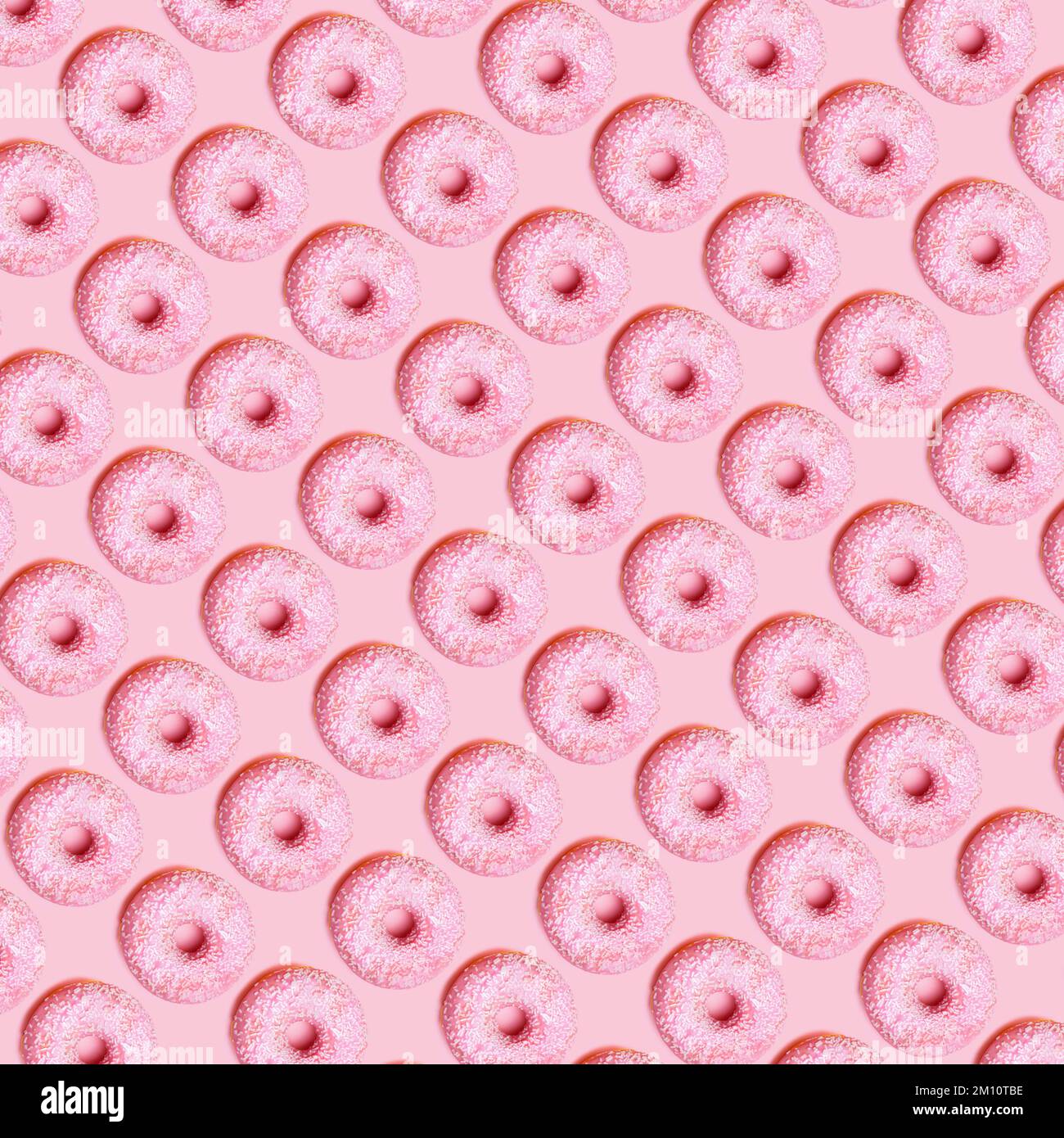 A pattern of pink donut on a light pink background Stock Photo - Alamy