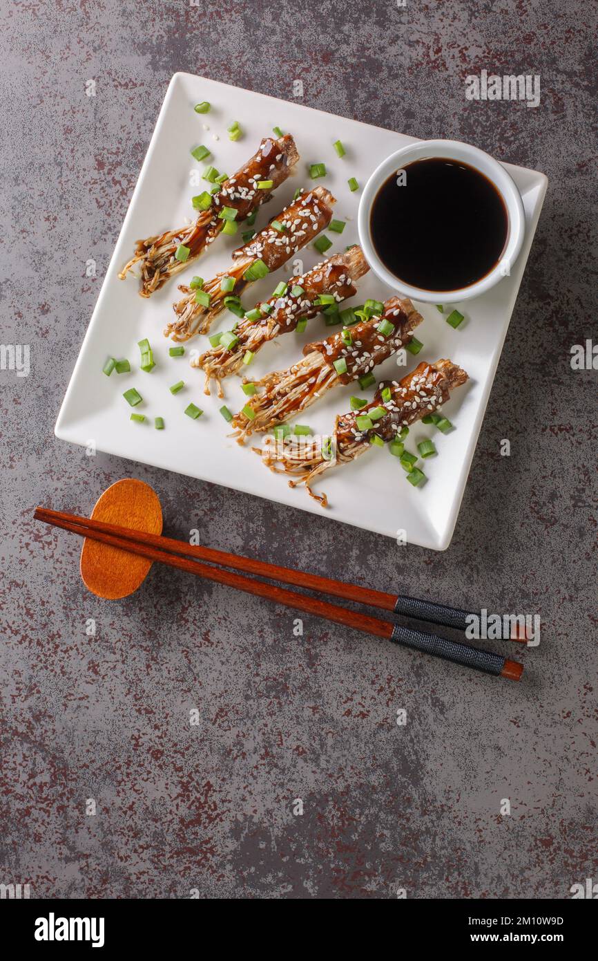 Japanese appetizer fried beef roll with enoki mushrooms with teriyaki ...