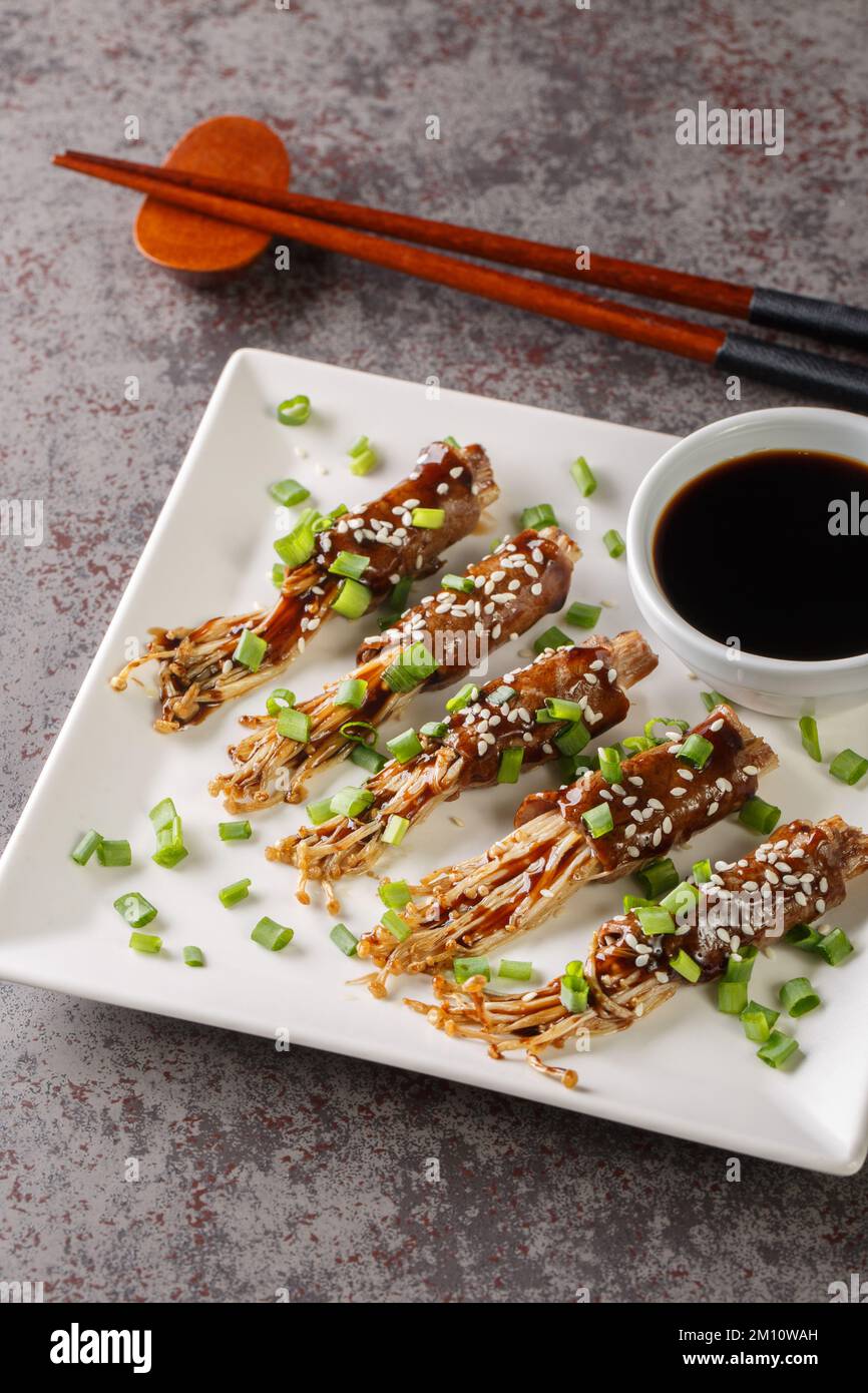 Japanese appetizer fried beef roll with enoki mushrooms with teriyaki ...